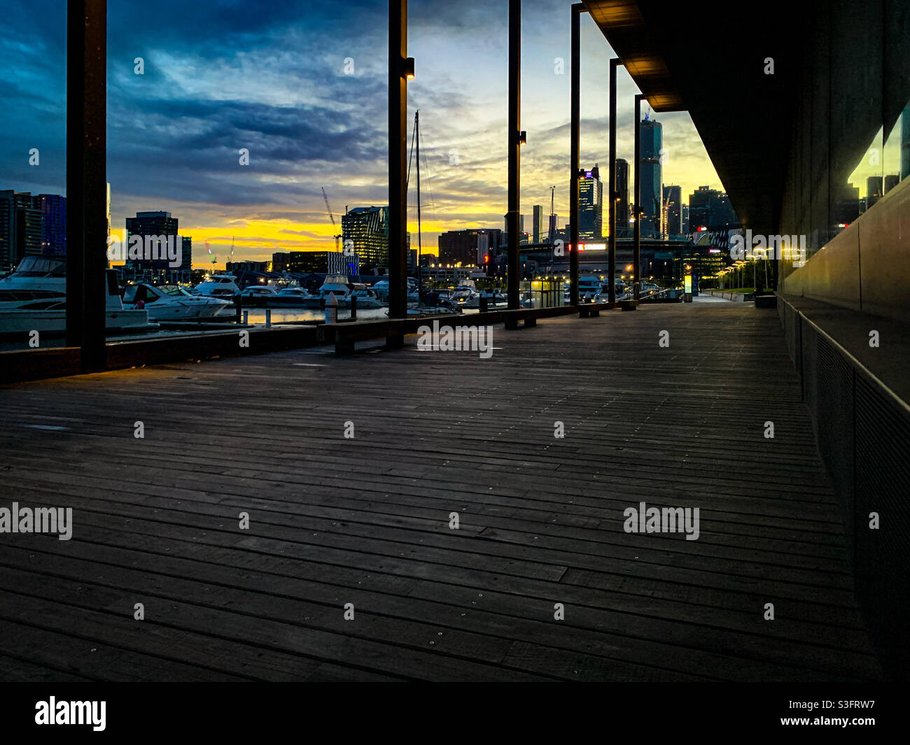 Boardwalk at Victoria Harbour, Docklands, at sunrise Stock Photo - Alamy