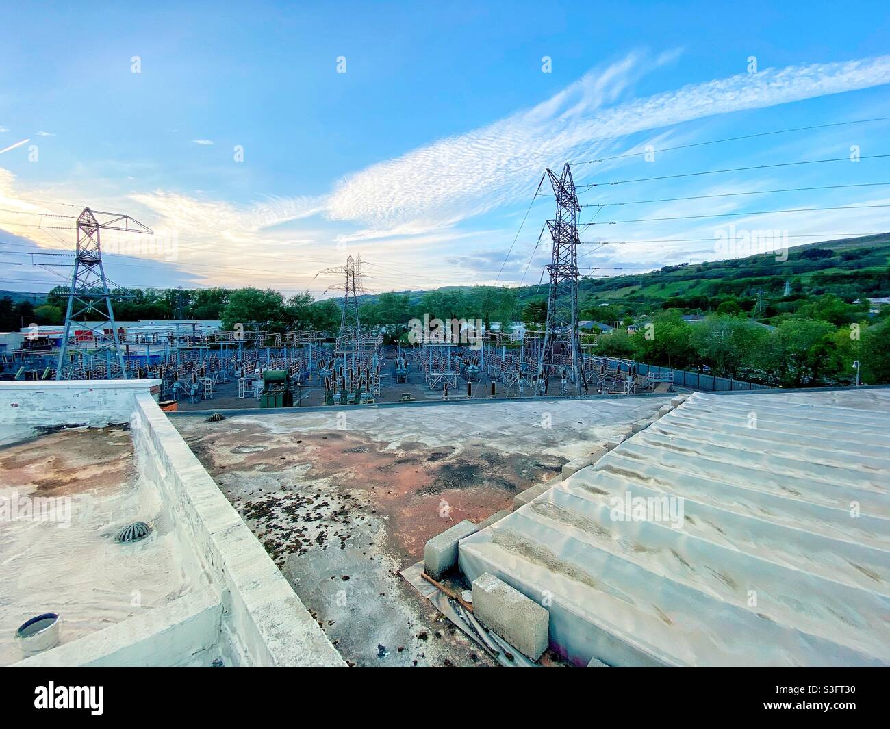 A photograph of an electricity substation with pylons and power lines ...