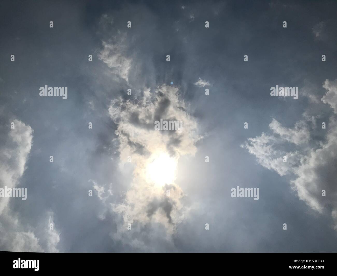 Sun reveal by clouds splitting away like a curtain. An eye in the sky ...