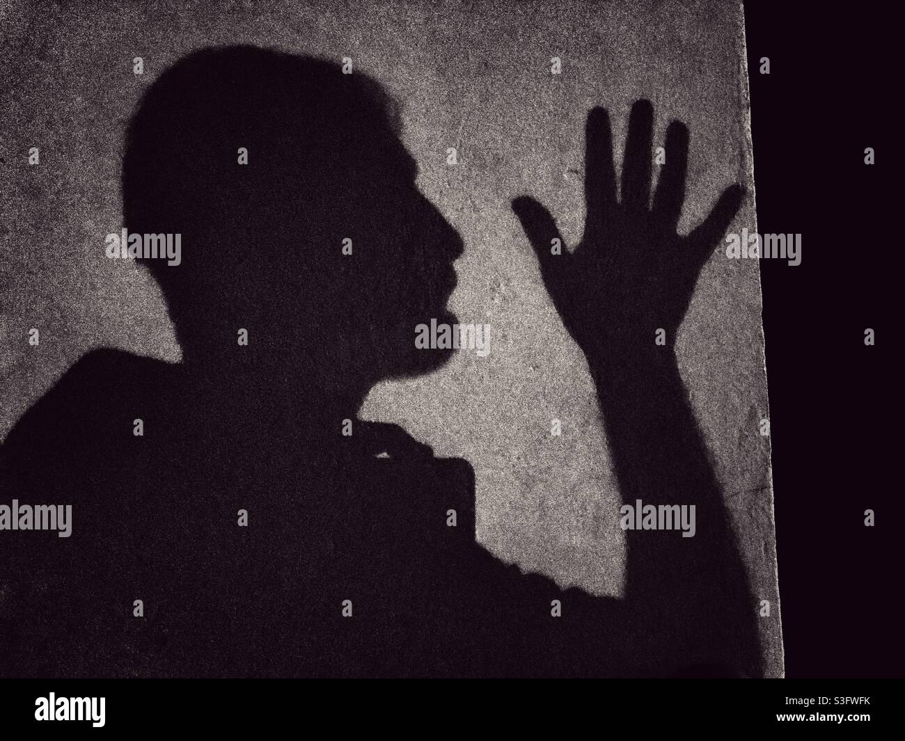 Silhouette of a man reflects on a wall Stock Photo - Alamy