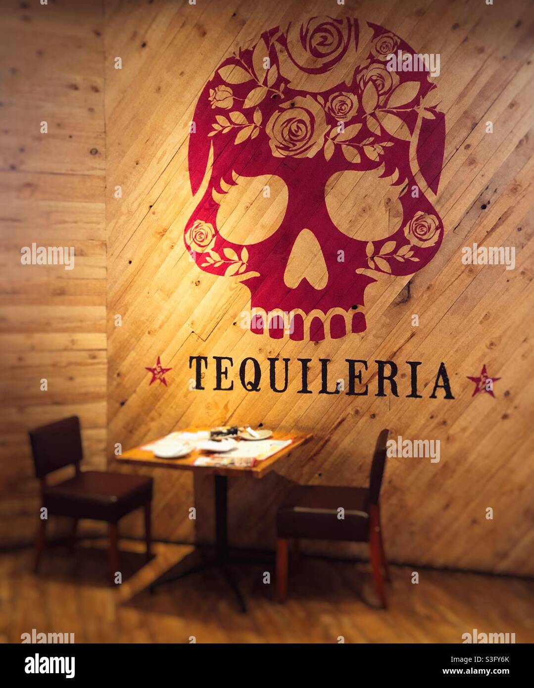 Painted skull on a wooden wall in a restaurant Stock Photo - Alamy