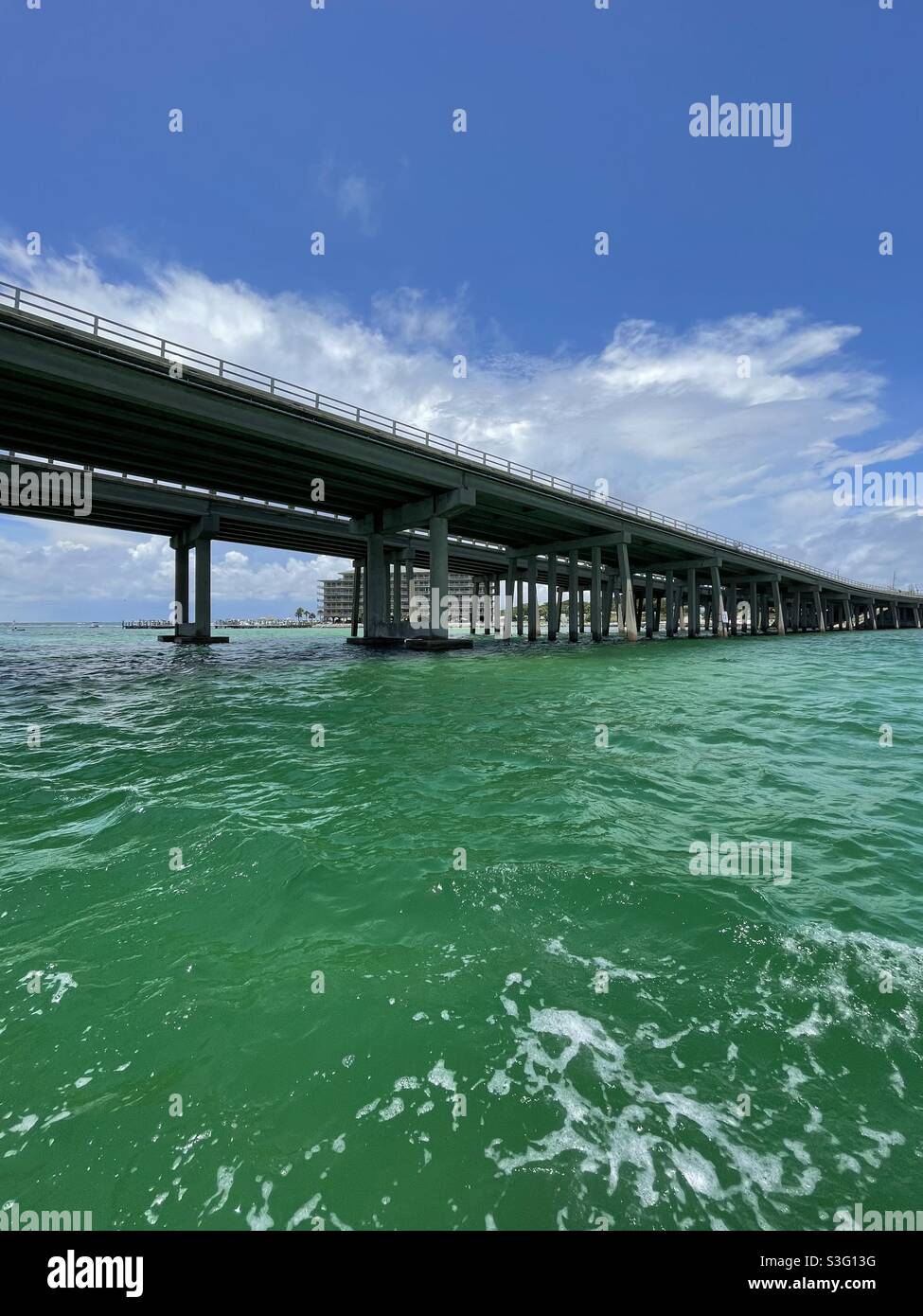 Destin, Florida bridge over deep green Gulf of Mexico water, boat view ...