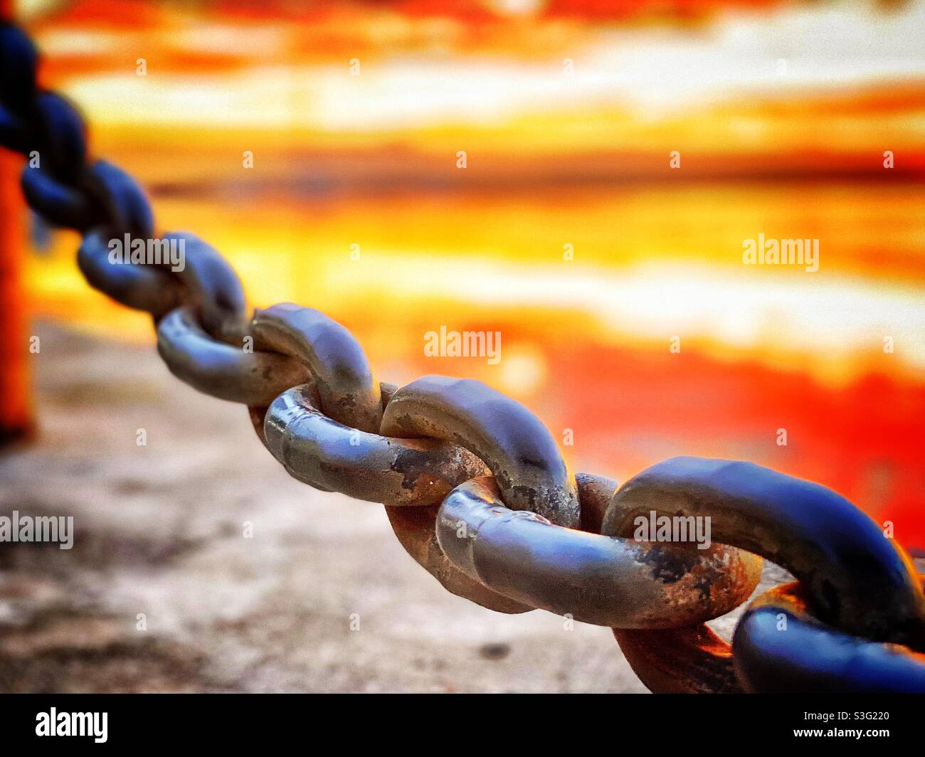 Chains against sunset Stock Photo - Alamy