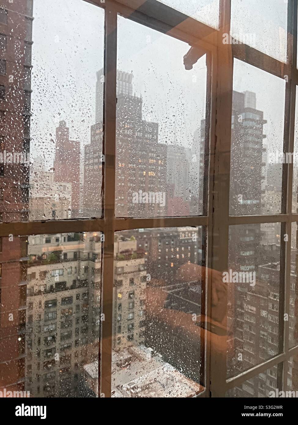A pouring rain storm as seen through a casement window in a New York ...