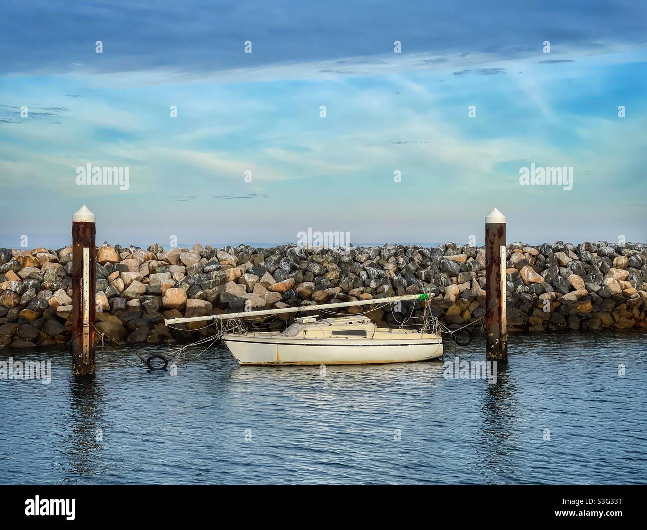 Sailboat with mast down moored in the harbor Stock Photo - Alamy