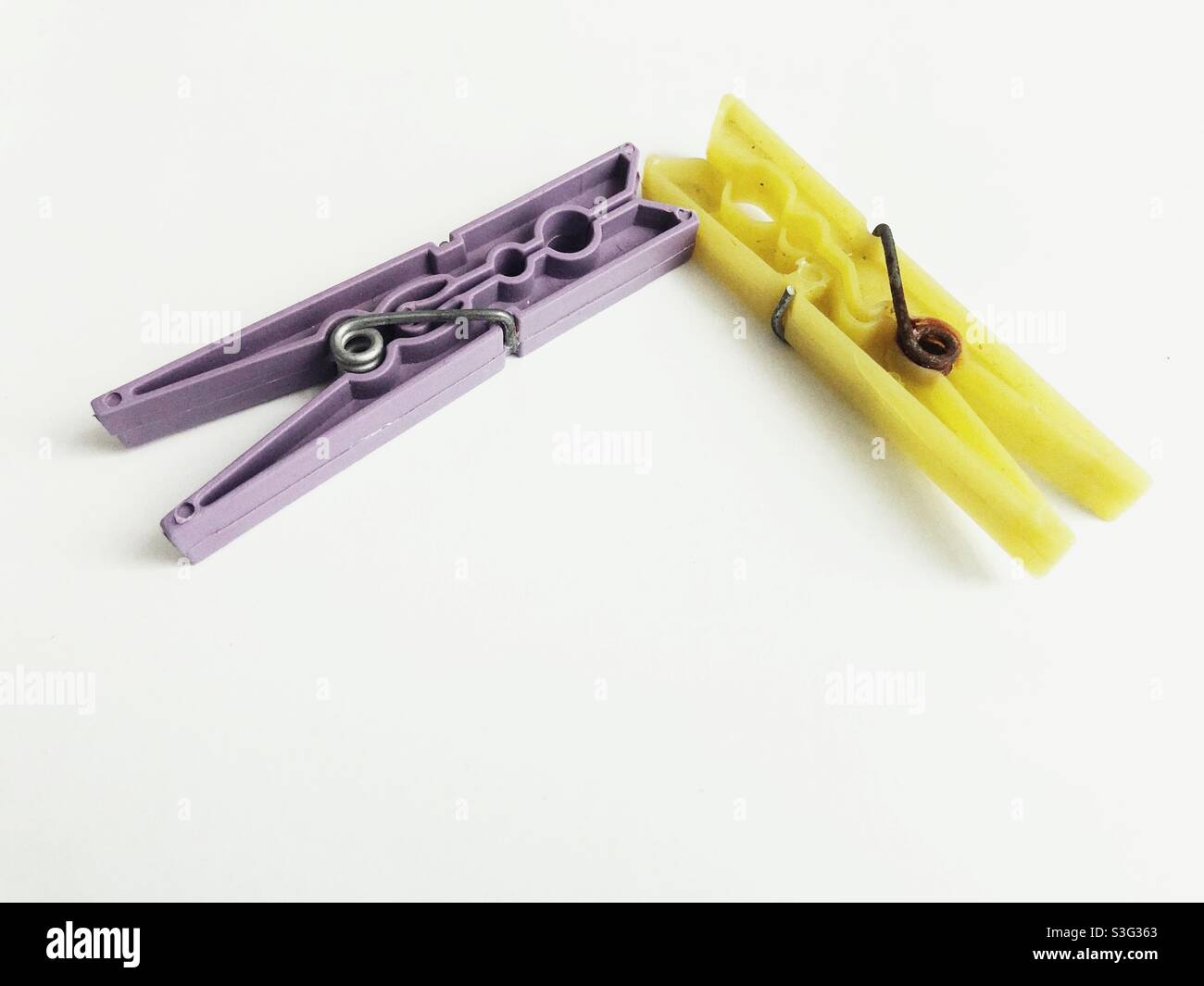 Two colourful pegs Stock Photo - Alamy