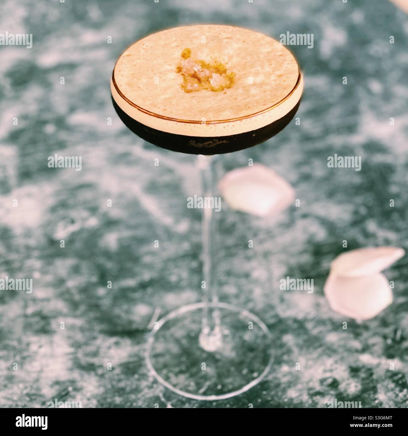 Cafe Shakerato in a martini glass with a granite texture background ...