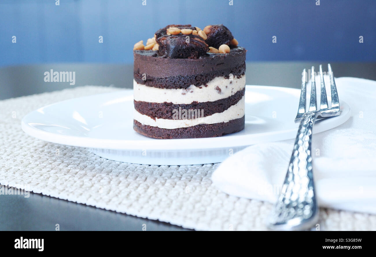 Sweet food, decadent chocolate mousse layered cake profile view plated ...