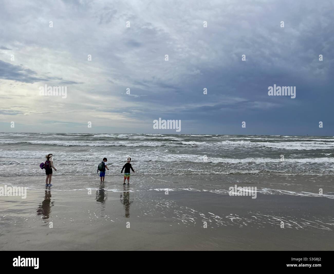 Kids with hiking gear on the beach of Mustang Island State Park in ...