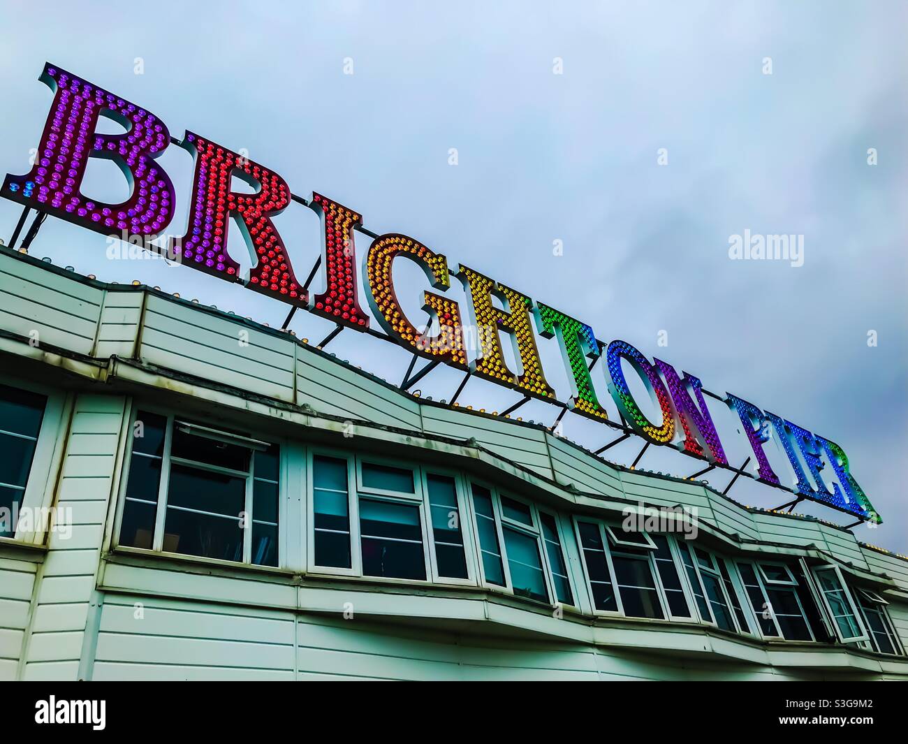 Brighton pier pride colours signage Stock Photo - Alamy