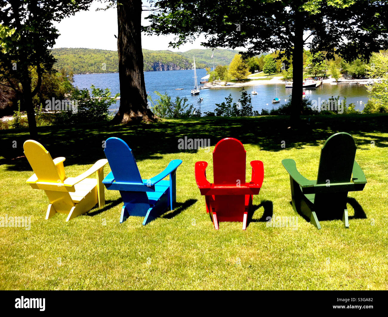 Colorful Adirondack chairs overlooking Lake Champlain Stock Photo - Alamy