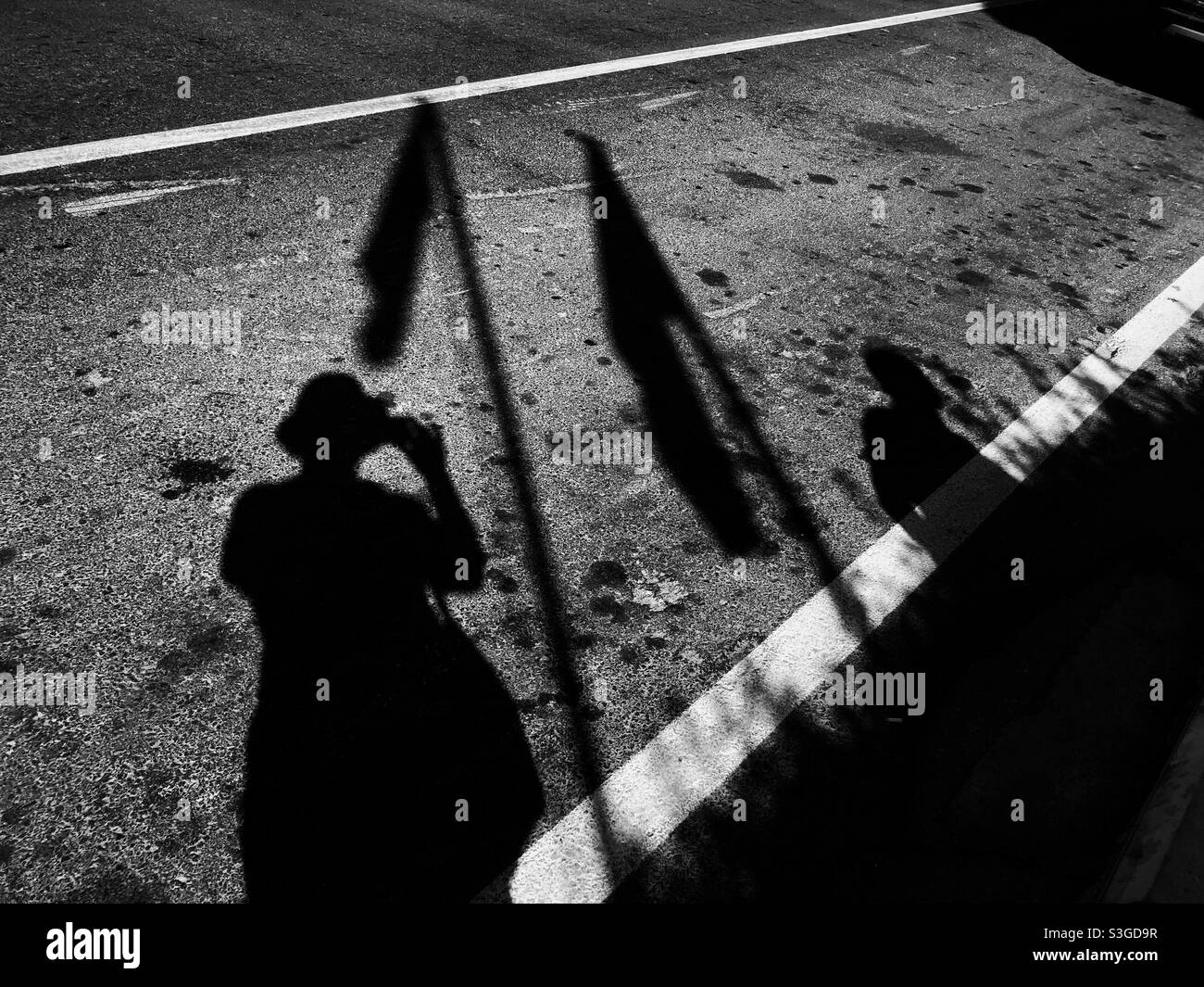 Silhouette of two man on asphalt surface Stock Photo - Alamy