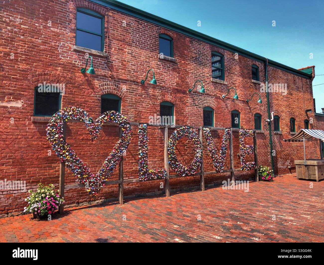 A Love locks structure forms a heart and the word love in front of a ...