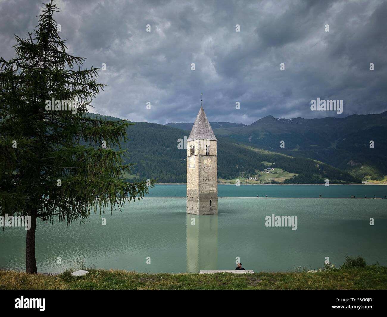 The steeple of the church submerged in the lake Reschen in Graun, Italy ...