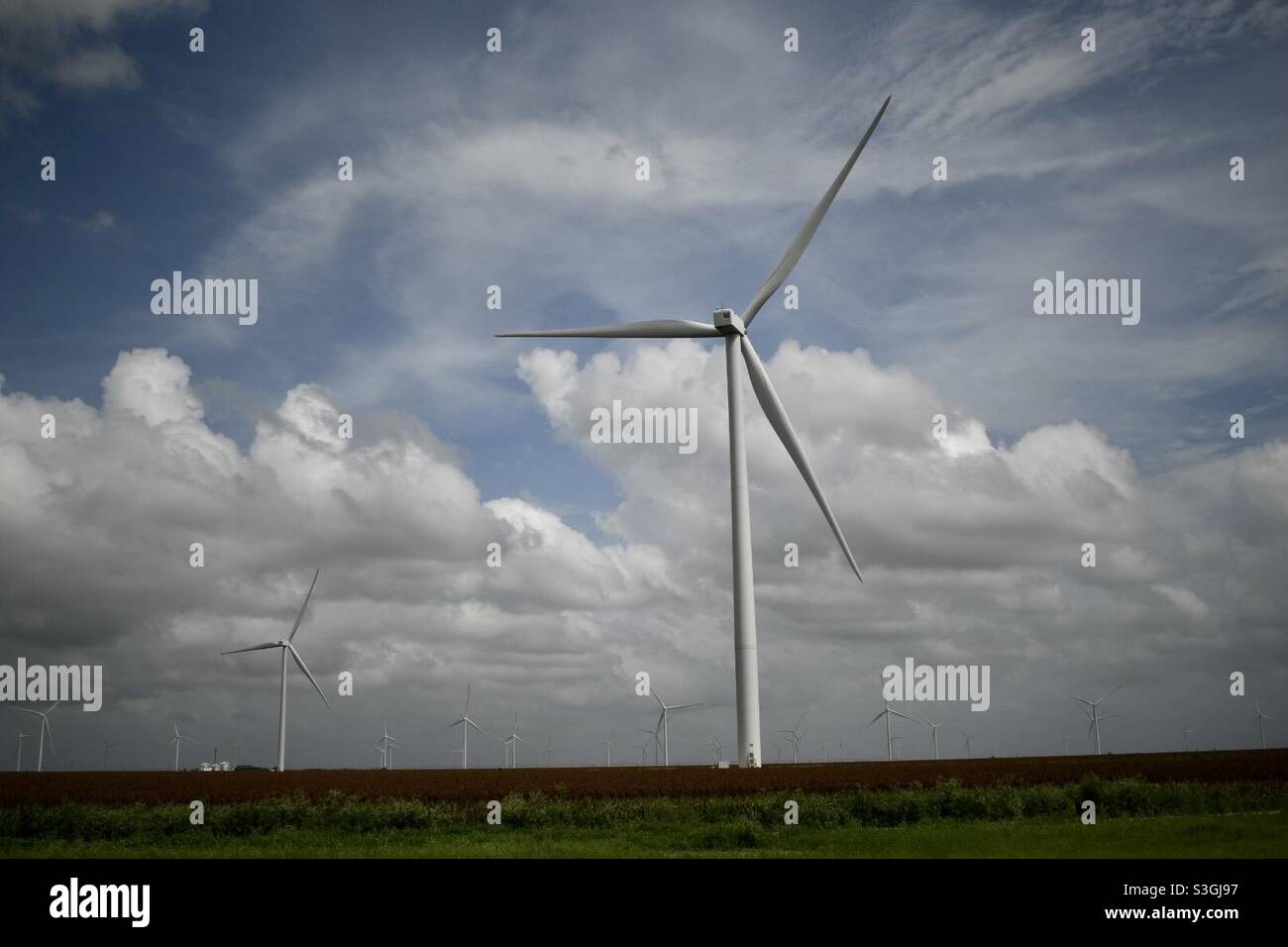 Wind turbines against a cloudy skyline Stock Photo - Alamy