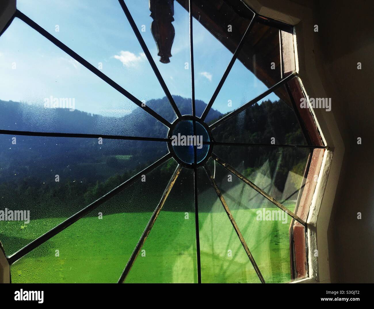 View on the mountains through a special window Stock Photo - Alamy