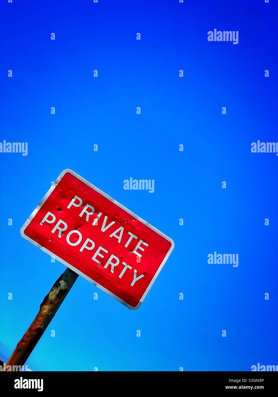 Private property sign against a clear blue sky Stock Photo - Alamy