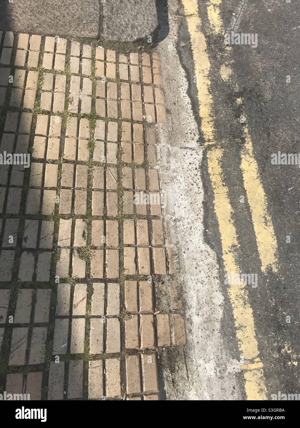 Double yellow lines and pavement with shadows and sharp lines Stock ...