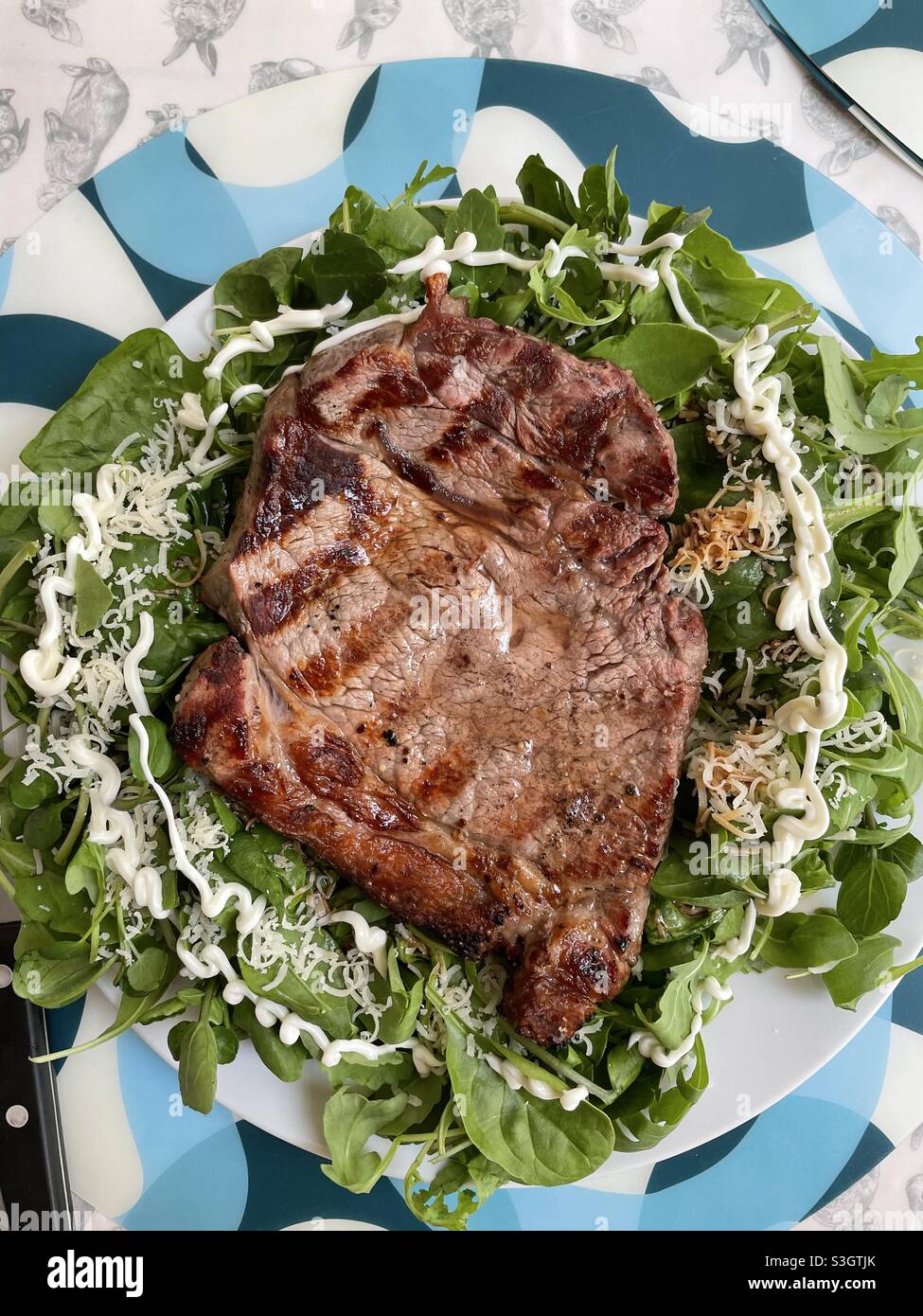 Giant steak on a salad Stock Photo - Alamy