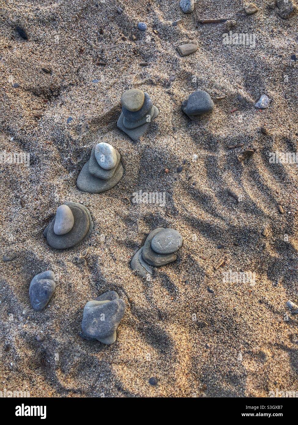 Mini stone piles arranged on the sand in the shape of the Ursa Major ...