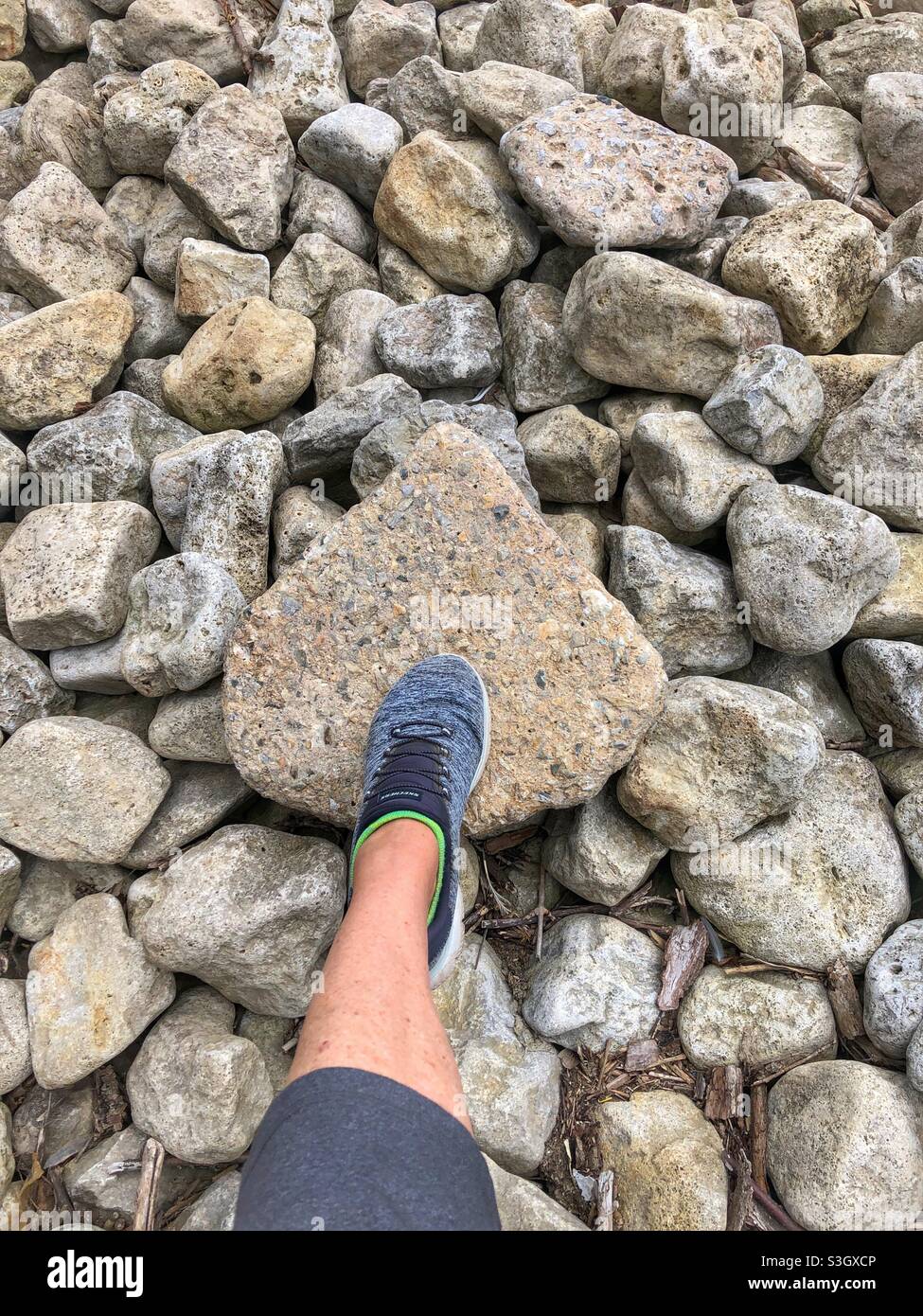 Woman walking on rocks hi-res stock photography and images - Alamy