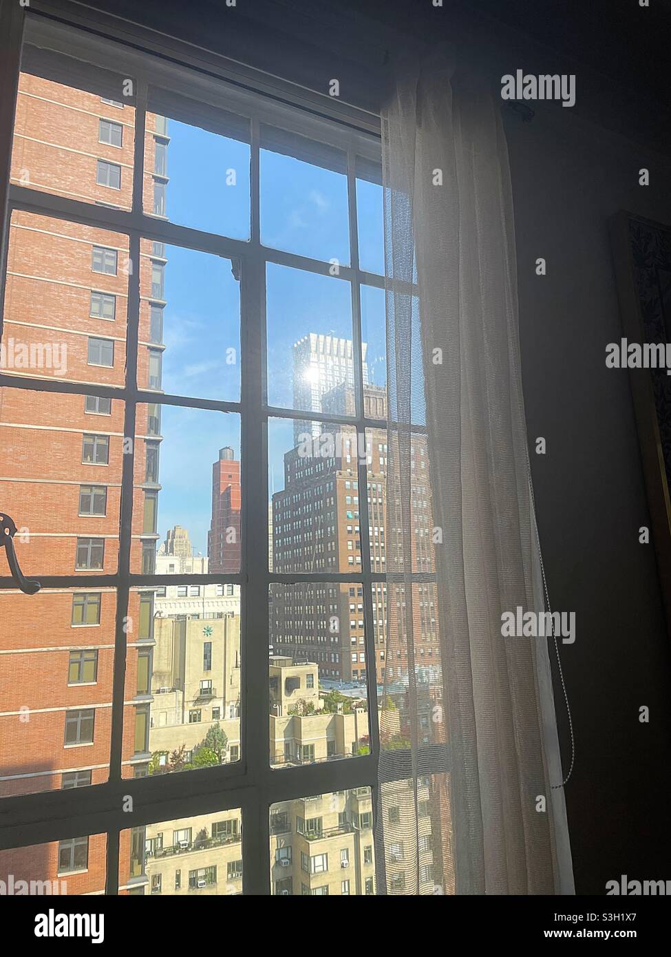 Sunspot on a modern skyscraper as seen through in Murray Hill apartment ...