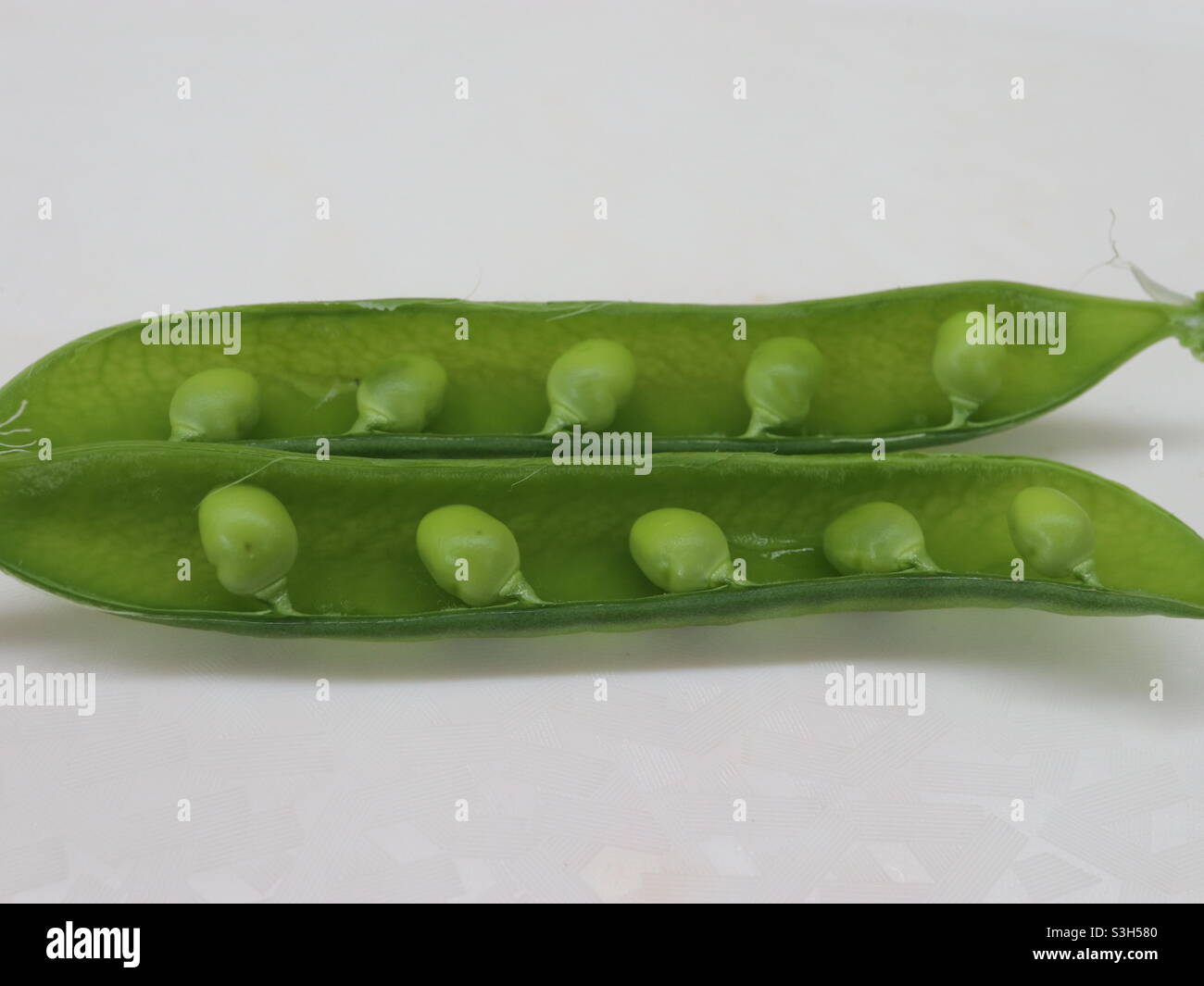 Peas in a pod Stock Photo - Alamy