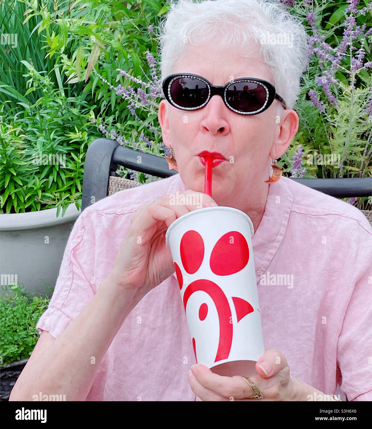 woman pensioner enjoying her Chick-fil-A sweet iced tea, NYC, USA, 2021 ...