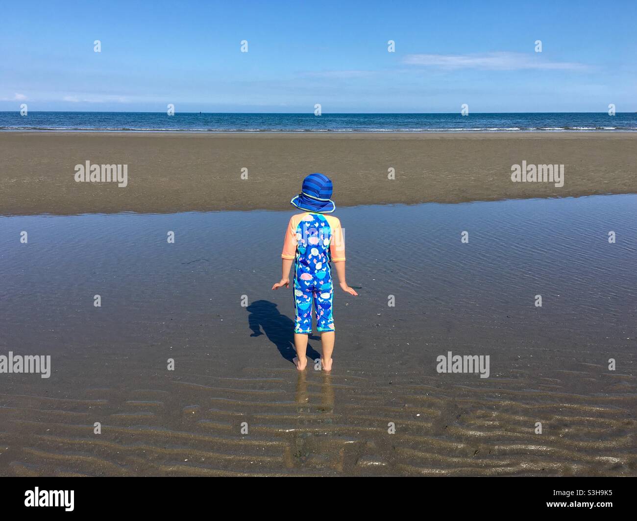 Child standing in shallow water hi-res stock photography and images - Alamy
