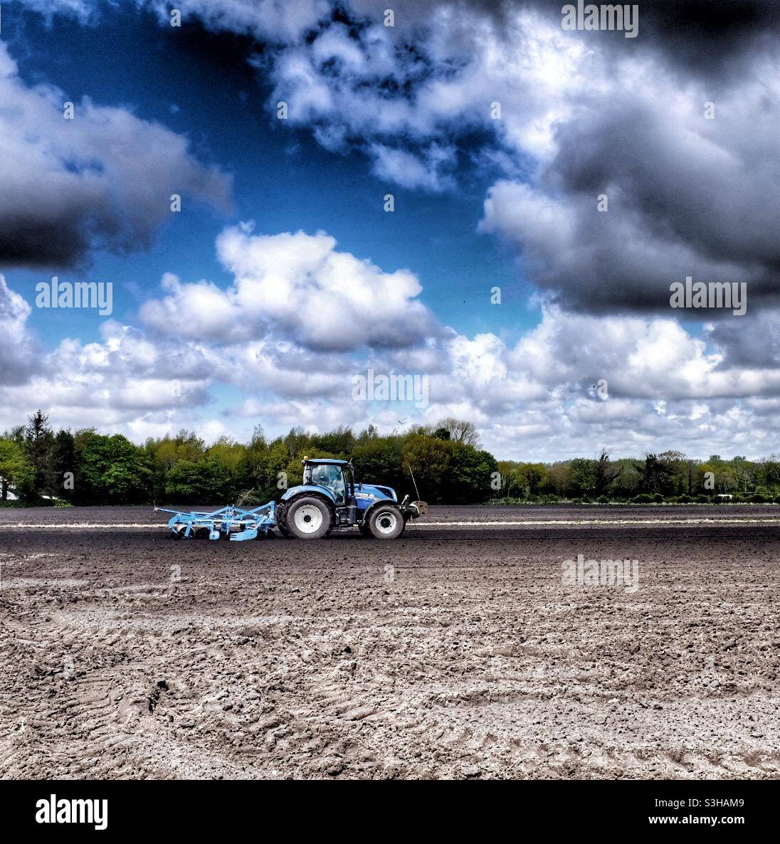 Blue tractor ploughing hi-res stock photography and images - Alamy