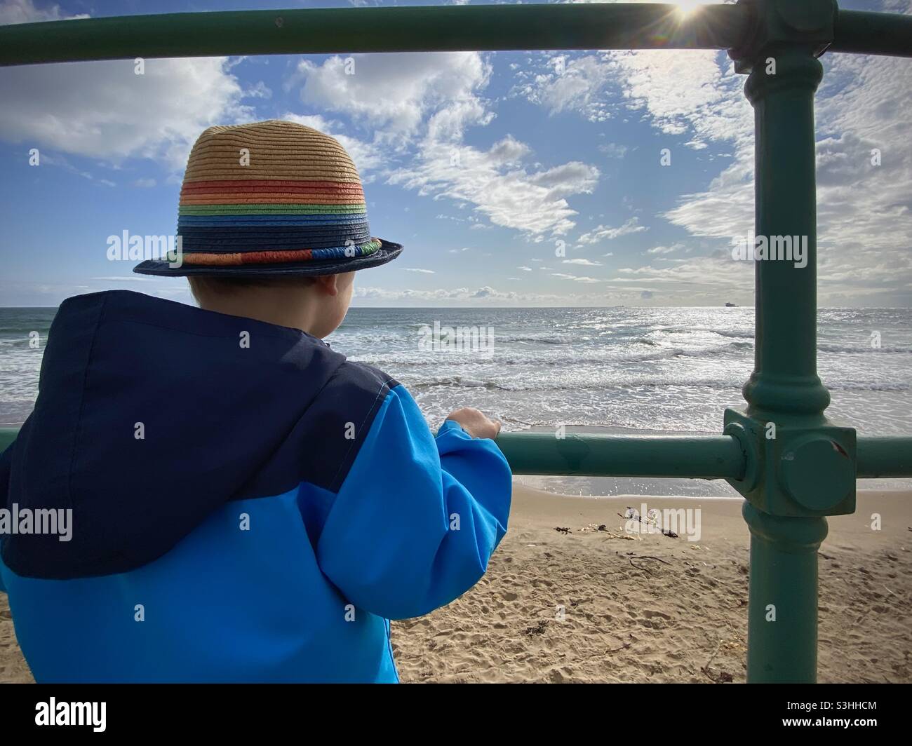 Young boy looking out to sea Stock Photo - Alamy