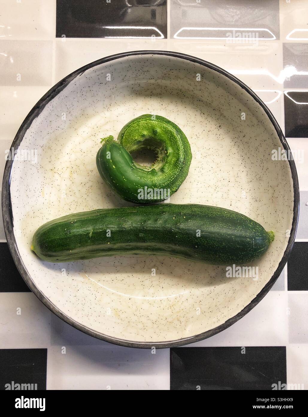 Organic irregular shaped cucumber in a bowl Stock Photo - Alamy