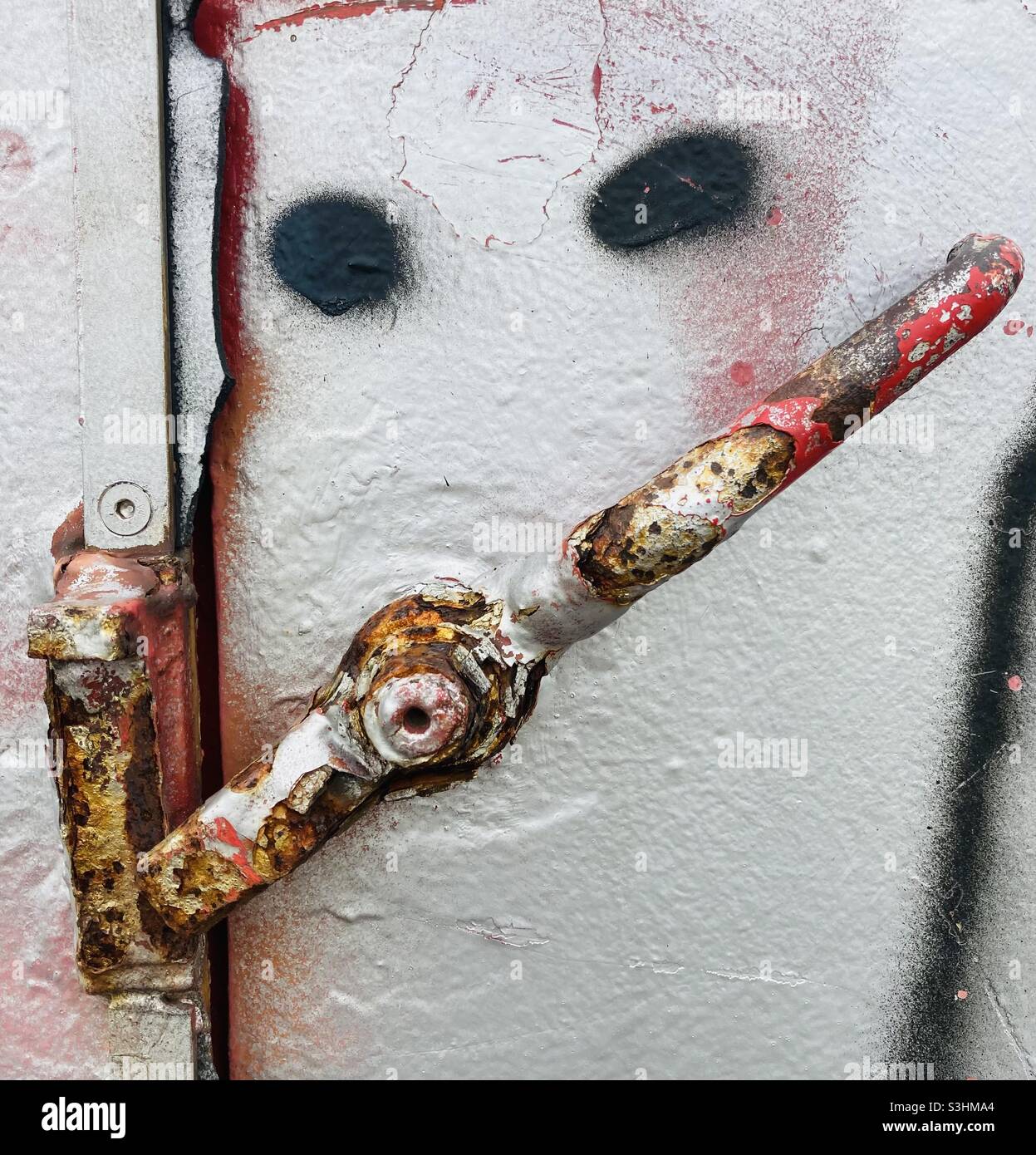 Rusty clamping lever with „eyes“ Stock Photo - Alamy