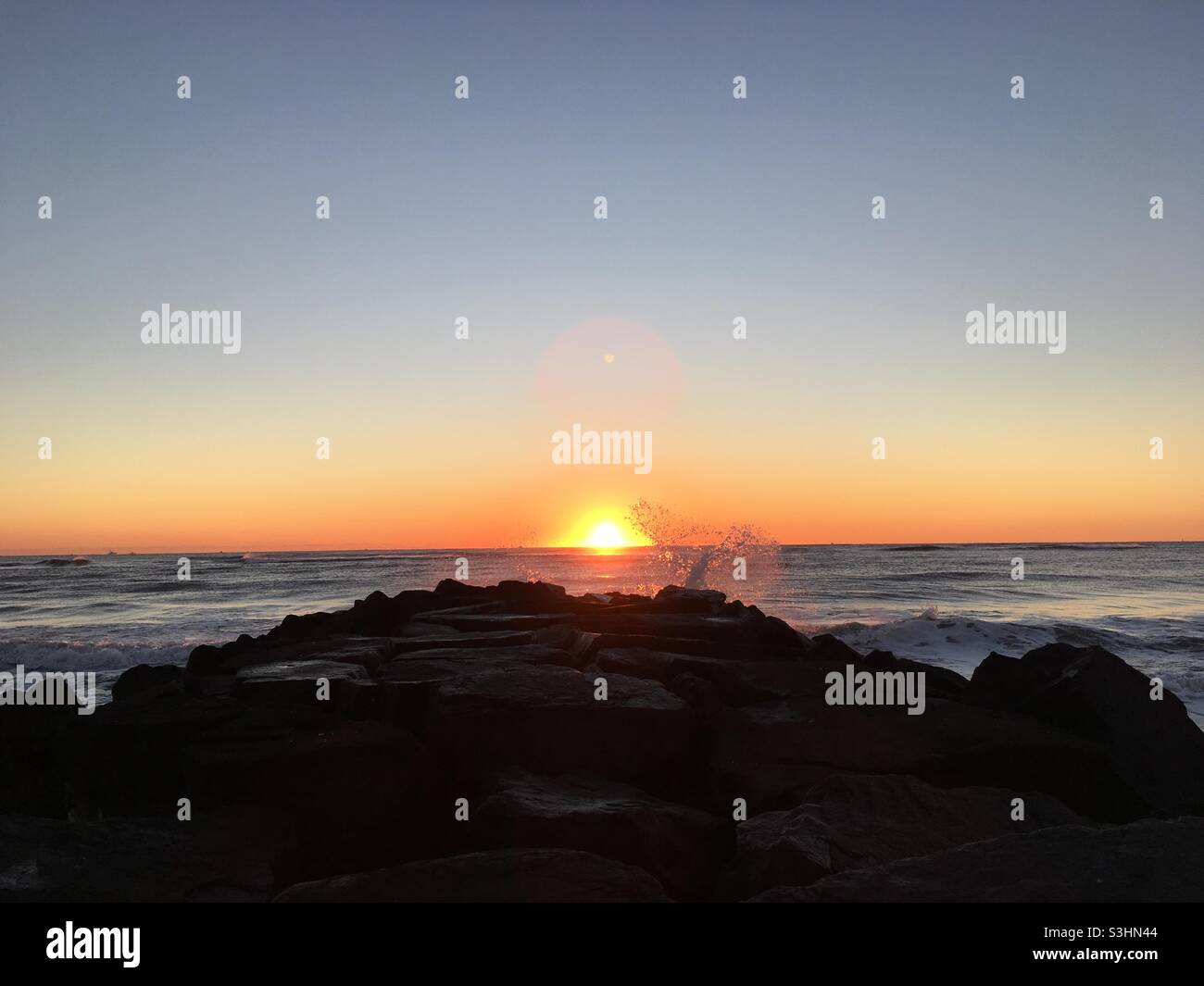 Sunrise over ocean Stock Photo - Alamy