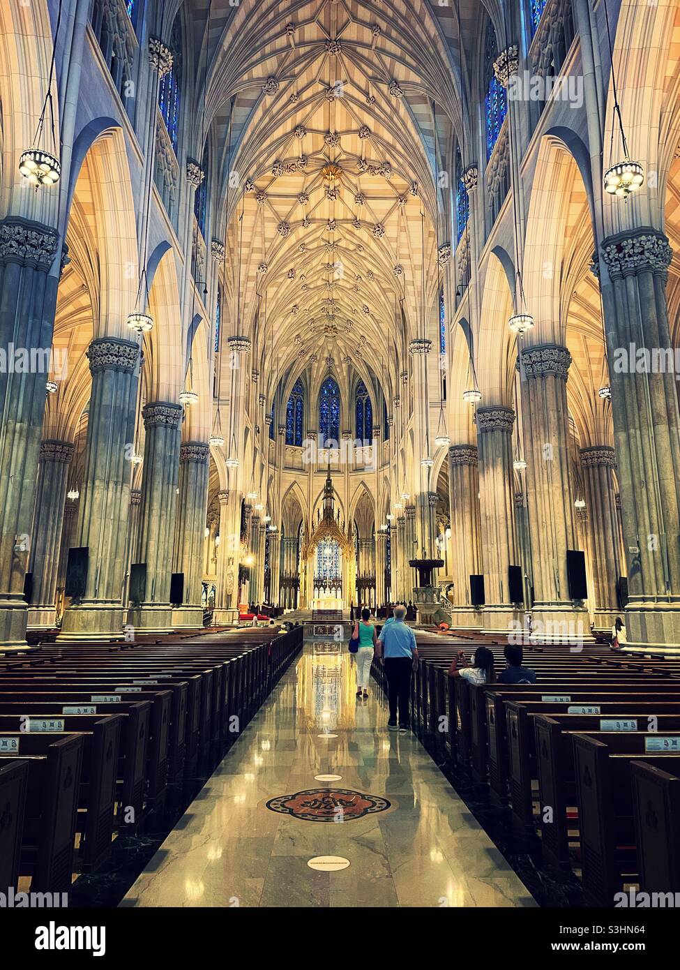 The main aisle and wooden pews looking at the altar in St. Patrick’s ...