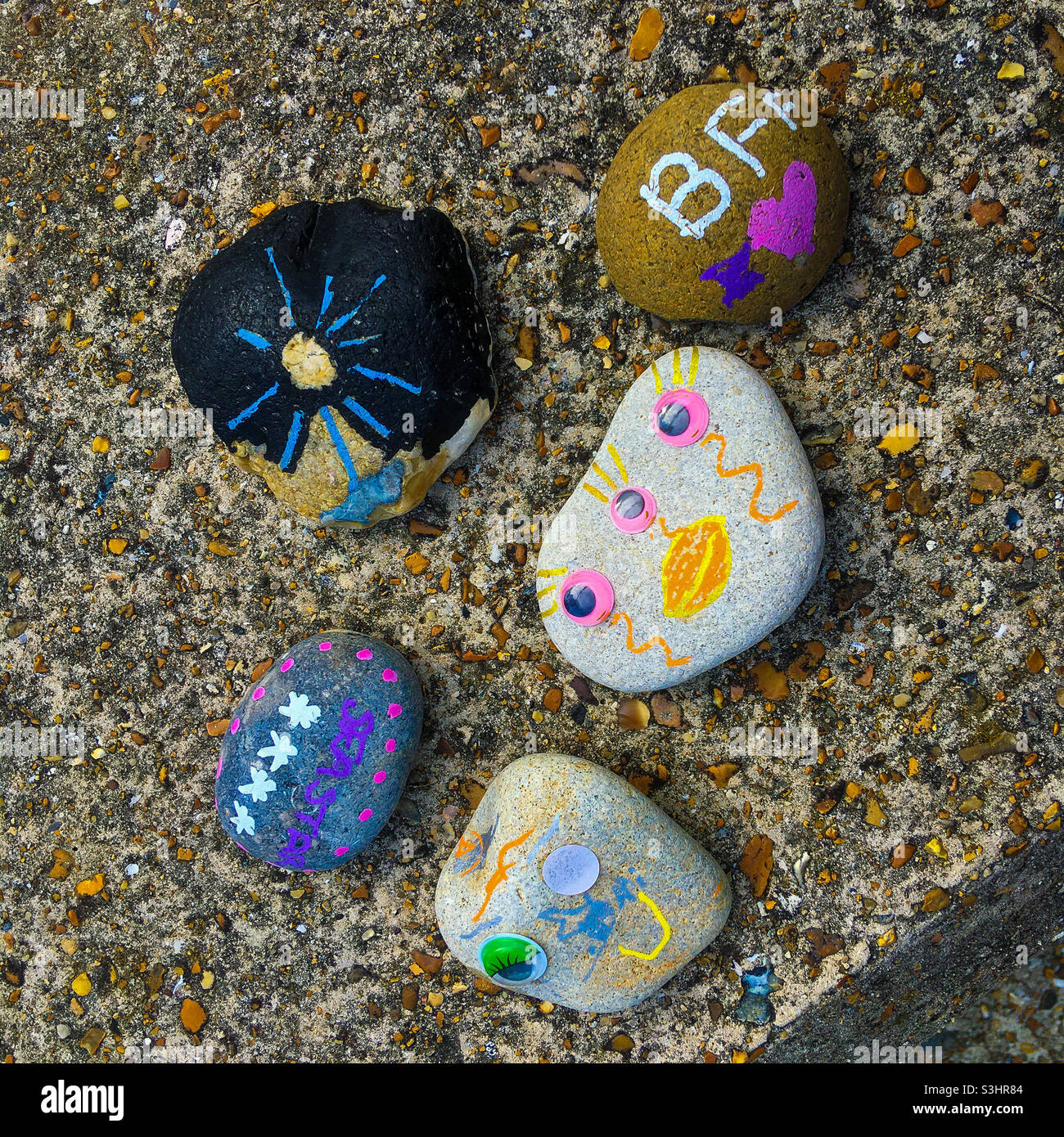 Painted Stones on a wall Stock Photo - Alamy
