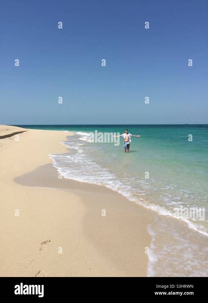 Kuwaiti island with obscured person on white sand Stock Photo - Alamy