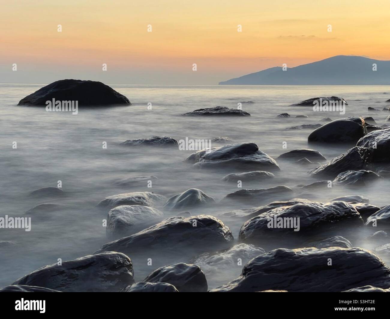 Water and rocks at dusk looking towards Bolus Head and BallinSkellig ...