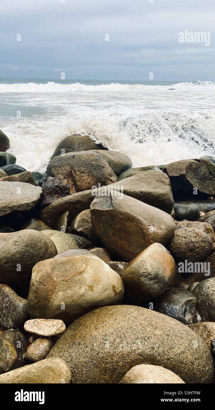 Beautiful sunny landscape of the sea with big brown rocks on the beach ...