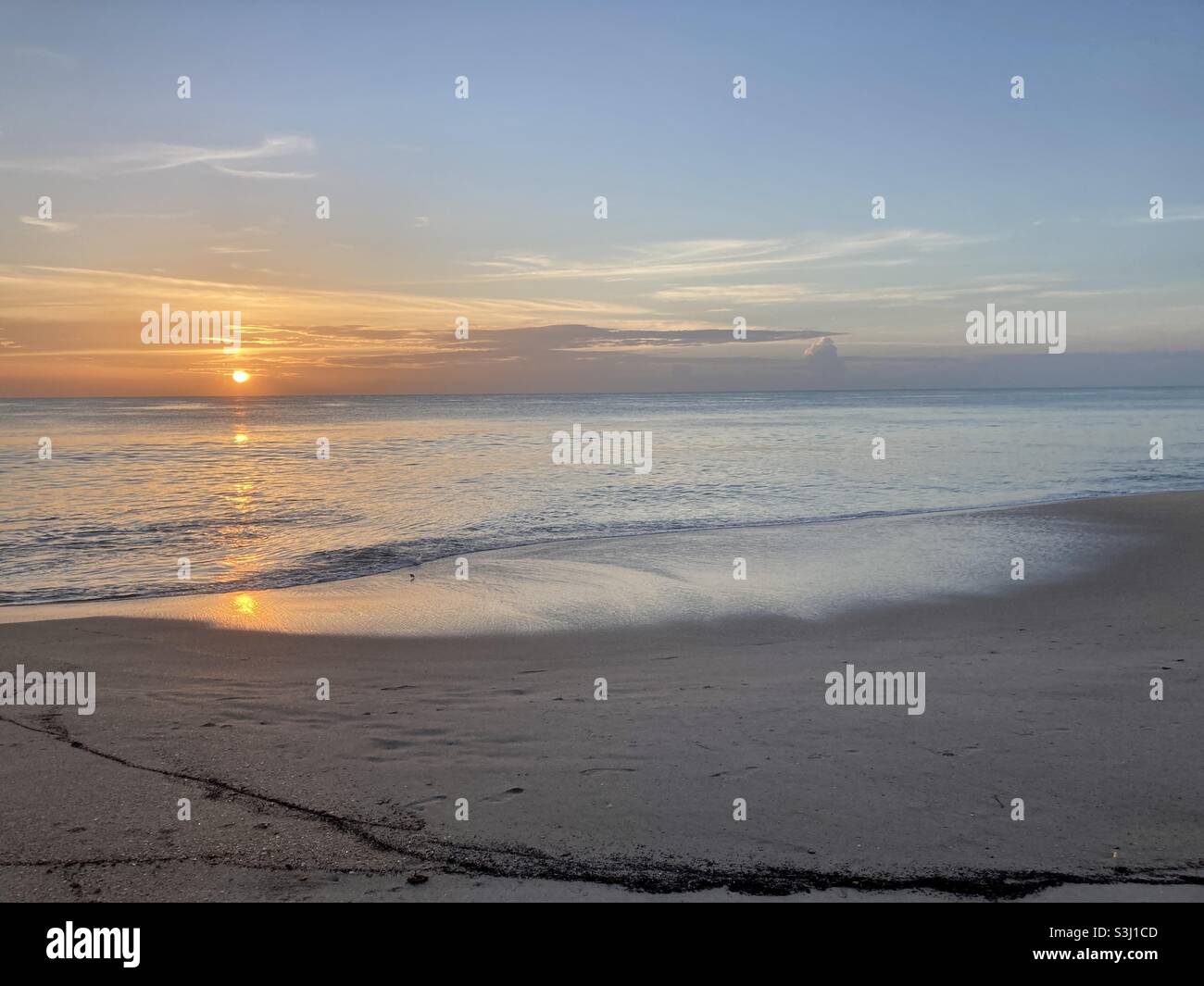 Sunrise over a calm Atlantic ocean Stock Photo - Alamy