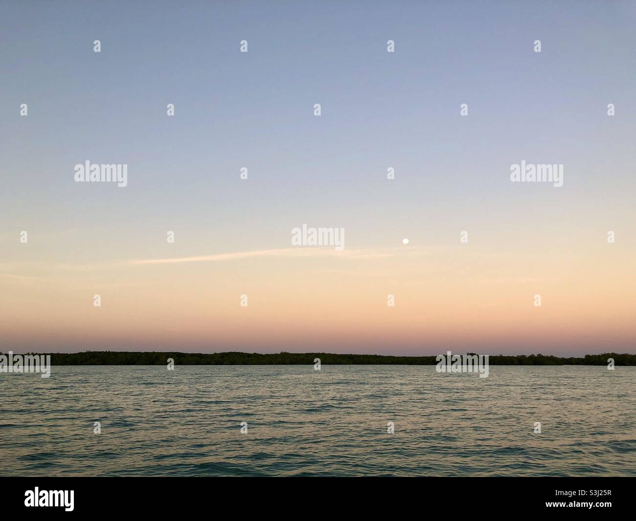 Moonrise over water Stock Photo - Alamy