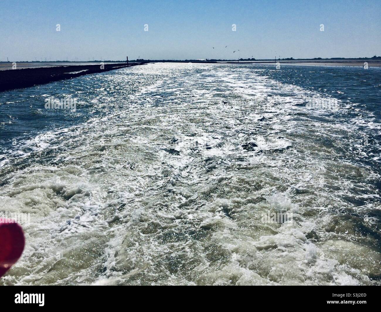 Stern waves of the ferry on the way to the German North Sea island ...