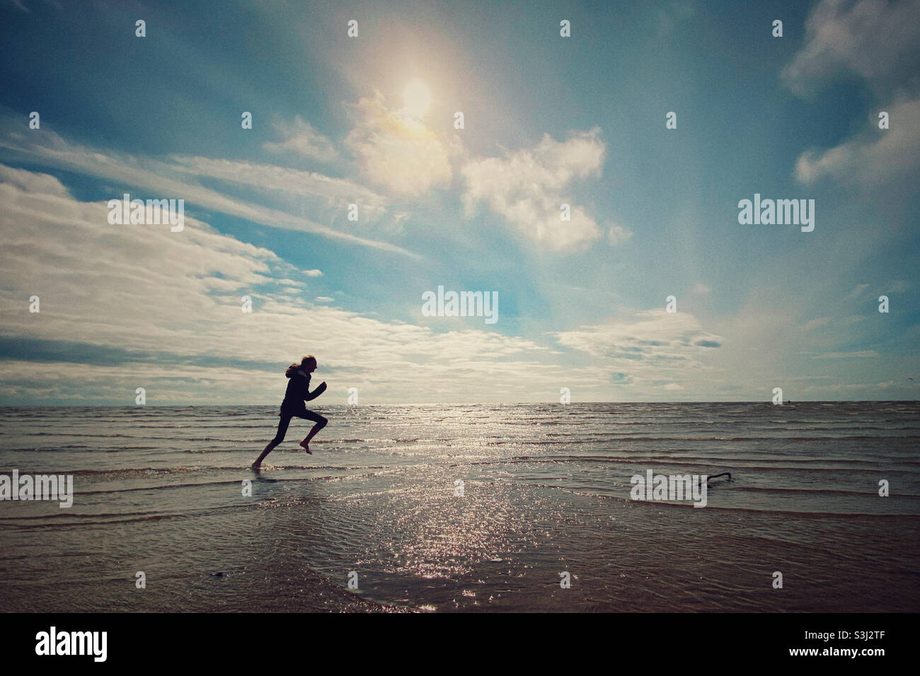 Girl running through the sea hi-res stock photography and images - Alamy
