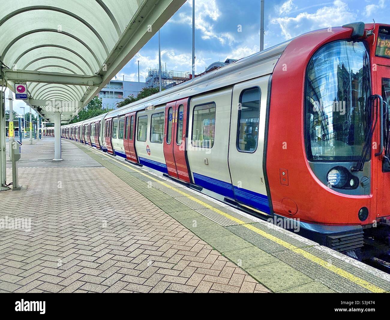 London district line tube train at Olympia railway station Kensington ...