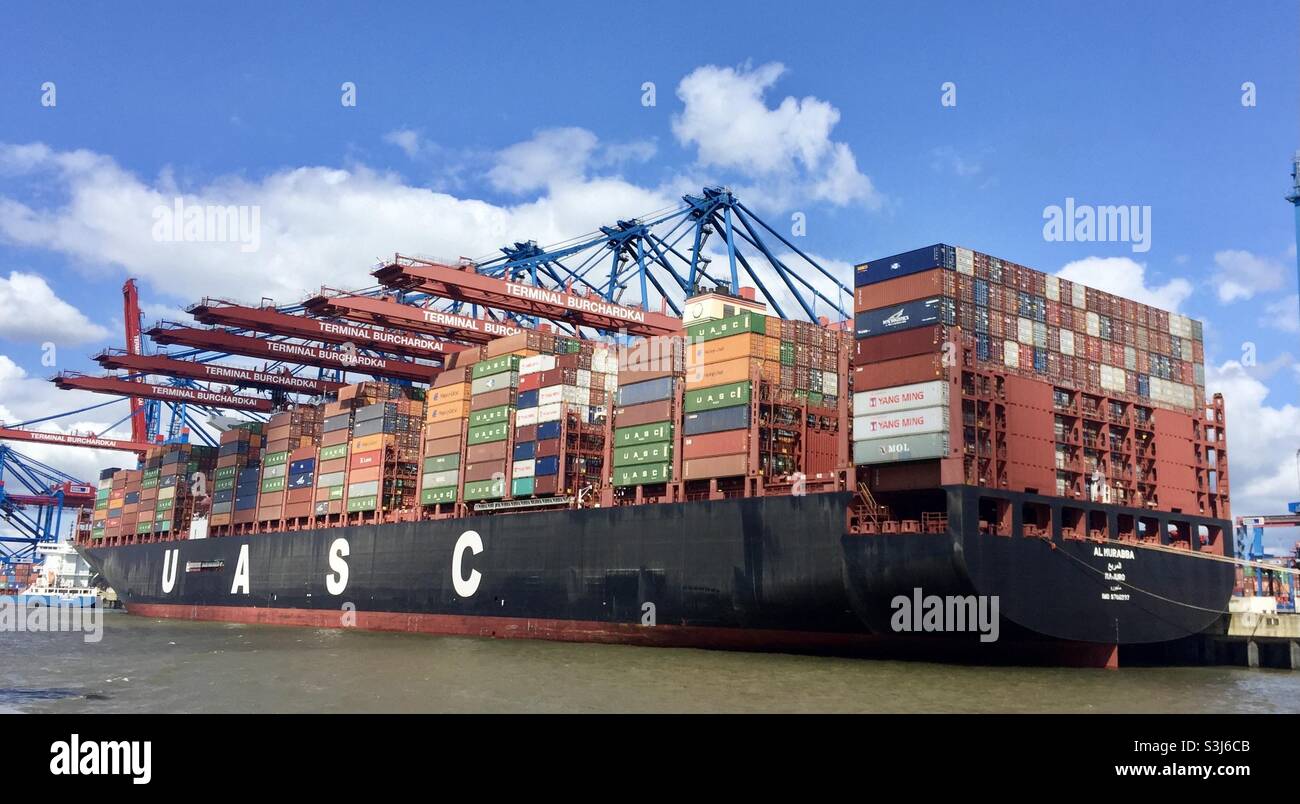 Heavy shipping load at dock Stock Photo - Alamy