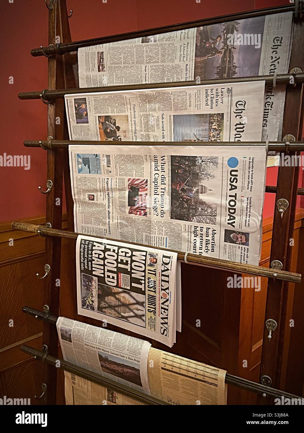 Rack holding daily newspapers in a private club, 2021, New York City ...