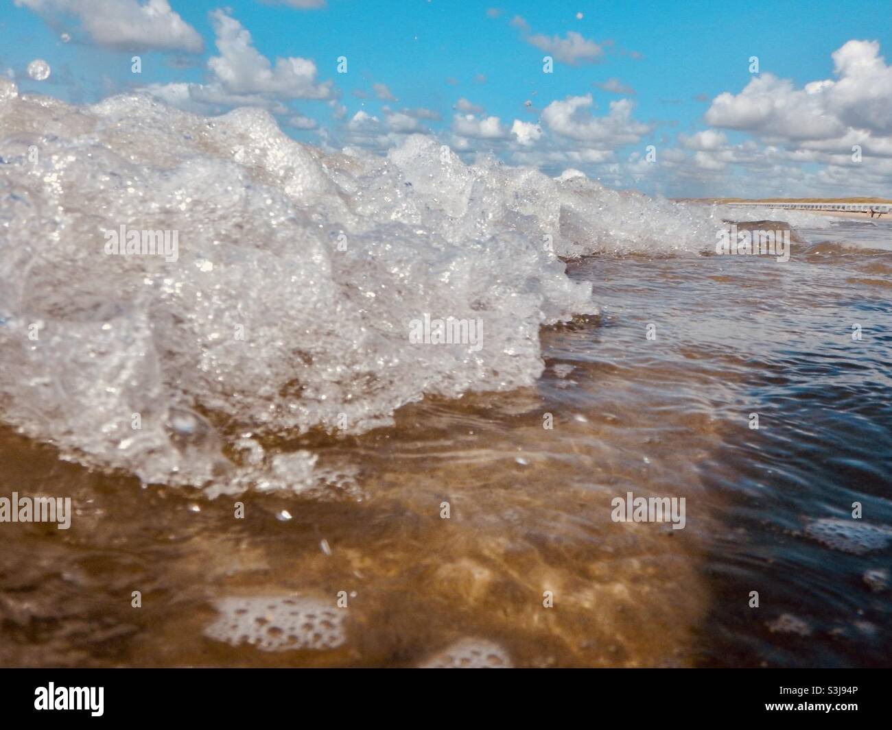 Water surge on the beach Stock Photo - Alamy