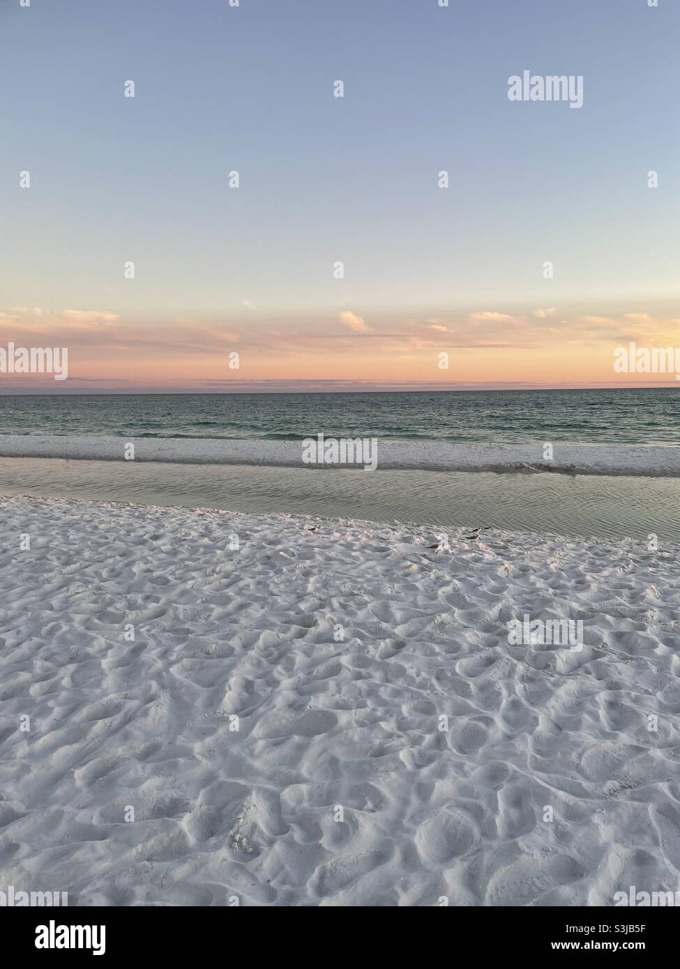 Pastel color sunset skies over emerald water of the Gulf of Mexico ...