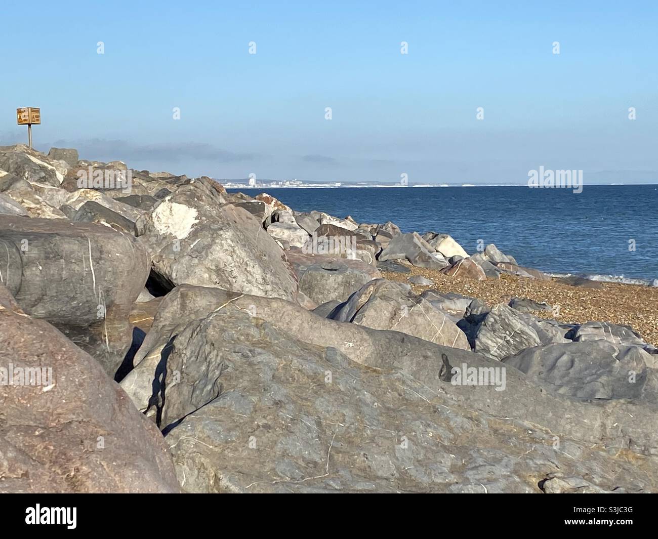 Sunny day at rock and pebble beach from Worthing with Brighton in the ...