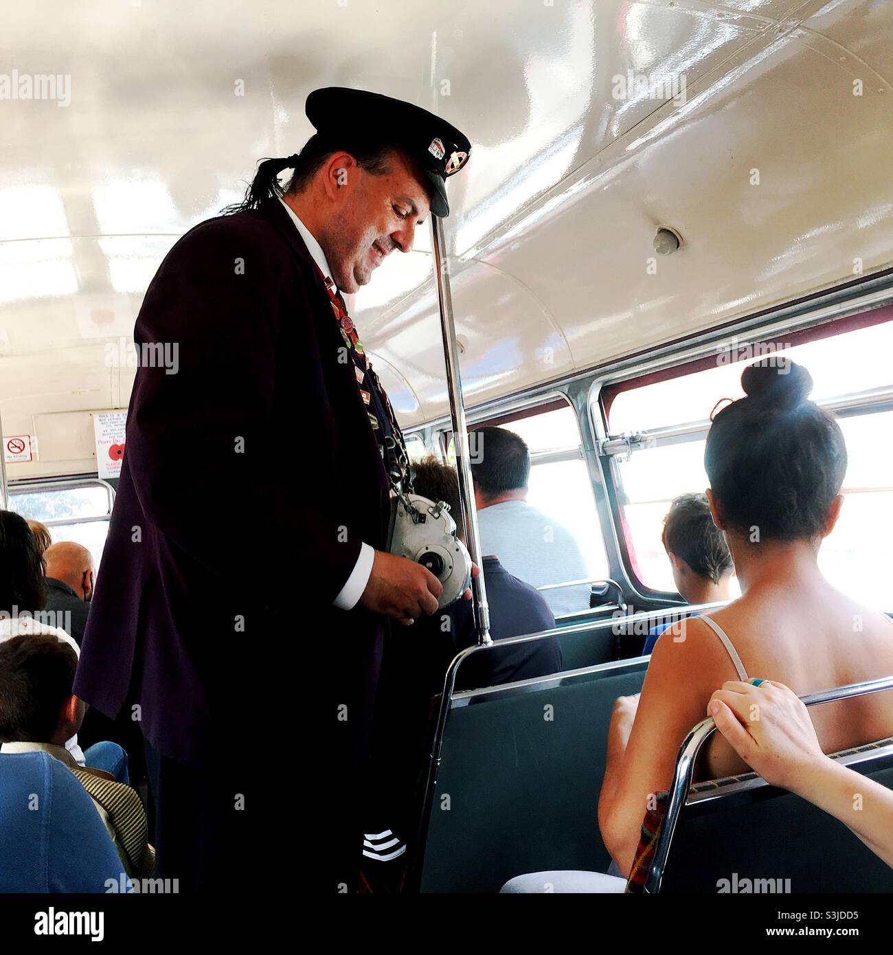 Bus conductor on route-master Stock Photo - Alamy